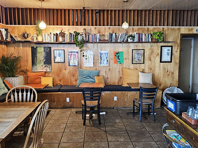 Library meets lunch spot in this wood-paneled sanctuary where books line the walls, colorful pillows invite lingering, and conversations flow as freely as the coffee.