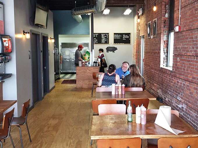 Simple wooden tables, exposed brick walls, and the intoxicating aroma of smoked meats create a temple of barbecue where conversation flows as freely as the sauce.