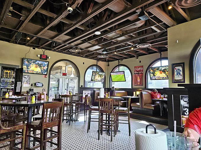 Exposed beams, arched windows, and multiple TVs create the perfect backdrop for both serious eating and casual sports watching.