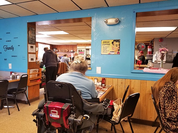 Blue walls and wood paneling create that perfect small-town diner atmosphere where conversations flow as freely as the coffee. No Instagram filter needed&mdash;or wanted.