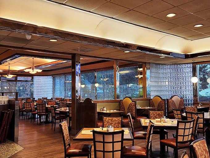 Warm wood tones and comfortable booths invite lingering conversations over bottomless coffee cups—the dining room equivalent of a reassuring hug.
