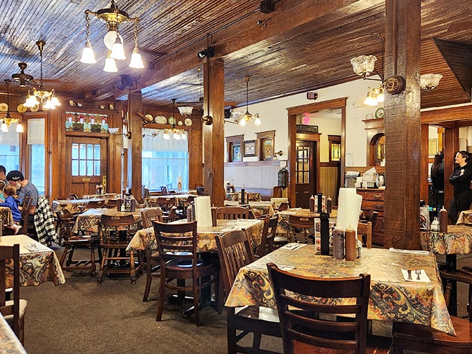 Wooden beams, vintage lighting, and floral tablecloths create that perfect "grandma's dining room meets smokehouse" vibe that makes comfort food taste even better.