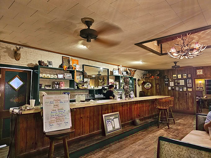 Step inside and time slows down. The wood-paneled walls, antler chandelier, and hunting trophies create an atmosphere no corporate restaurant could replicate.