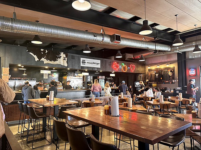 Industrial-chic meets Texas warmth inside, where exposed ductwork and communal tables create the perfect backdrop for barbecue worship.