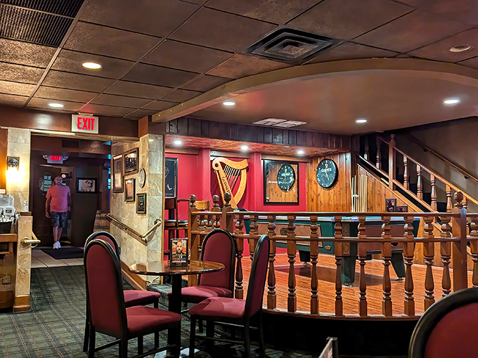Step inside and you're transported across the Atlantic. The warm wooden railings, red chairs, and golden harp create that perfect English pub atmosphere we all crave.