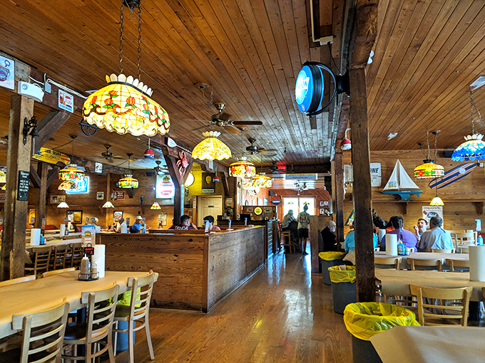 Warm wooden beams and colorful stained glass lamps create the perfect backdrop for the seafood drama about to unfold on your table.