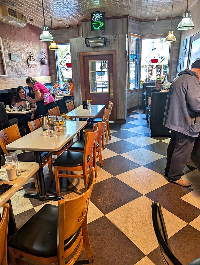 Inside, the classic black and white checkered floor and cozy booths create that perfect small-town diner atmosphere where breakfast dreams come true.