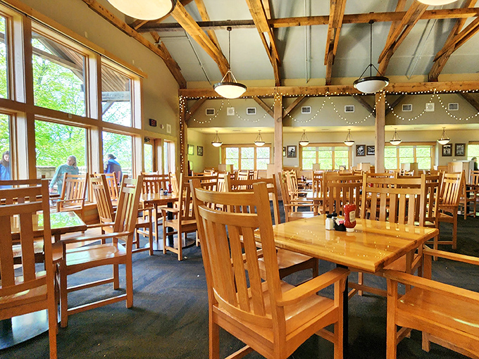 Exposed wooden beams and mission-style furniture create a dining room that feels like a sophisticated treehouse with a view.