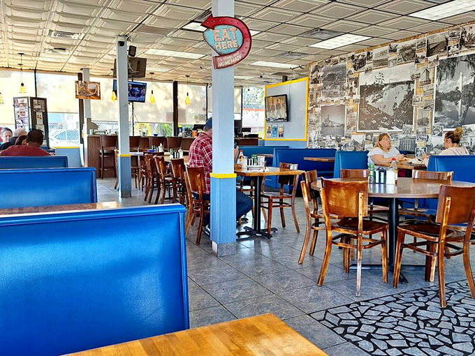 Blue booths, wooden tables, and walls covered in local history &ndash; this isn't interior design, it's comfort architecture at its finest. 