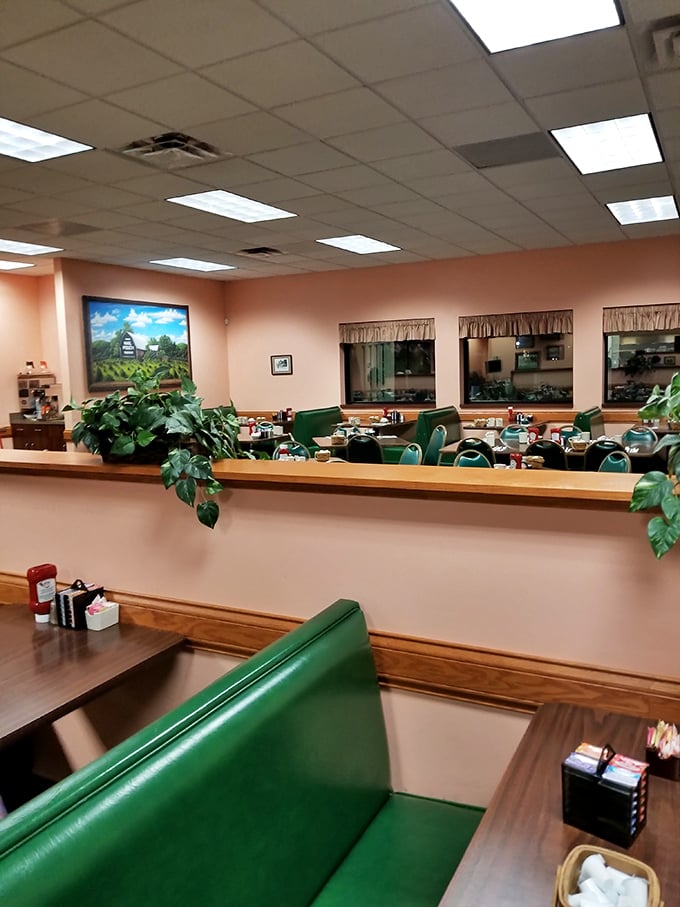 Classic green booths and peach walls create that perfect small-town diner atmosphere where comfort begins before the food even arrives.
