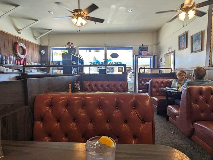 Those vintage burgundy booths have witnessed countless seafood love affairs, creating the perfect backdrop for serious eating business.