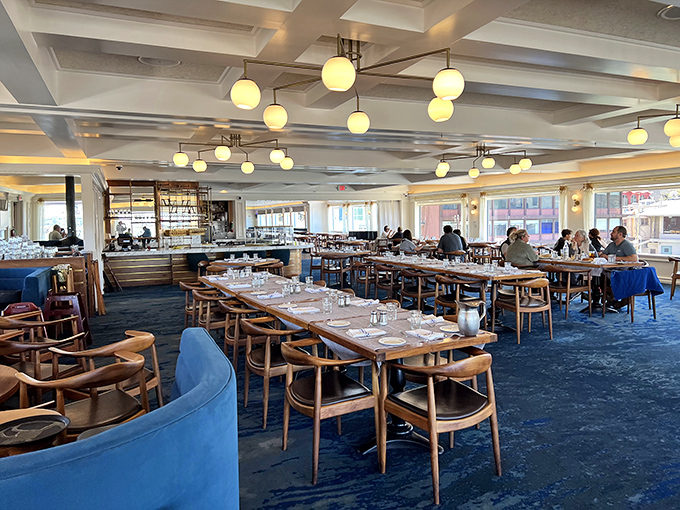 Inside, nautical elegance meets California casual with ocean-blue carpeting, warm wood furnishings, and globe lighting that makes everyone look like they're ready for their close-up.