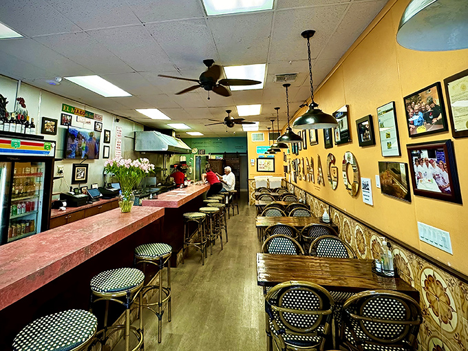 Inside, yellow walls adorned with framed memories create a warm embrace, while the counter offers front-row seats to the frita-making magic show.
