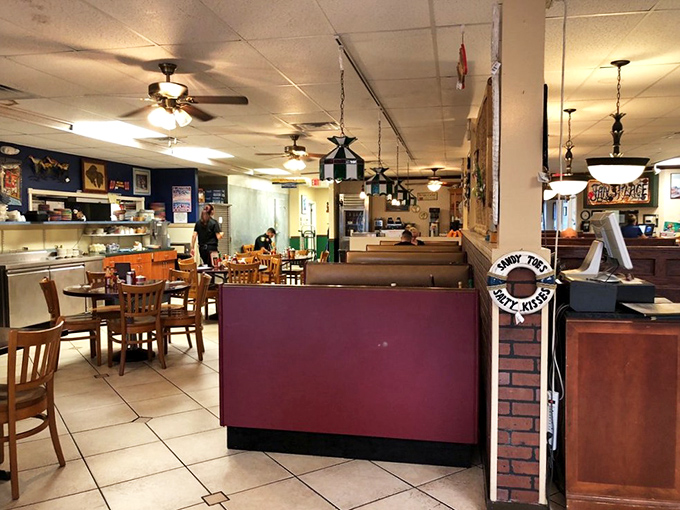 Inside, burgundy booths and wooden chairs create that perfect "been here forever" vibe where comfort trumps trendiness and conversations flow as freely as the coffee.
