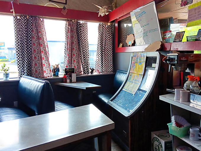 Black vinyl booths and checkered curtains create the perfect backdrop for life-changing burger moments. This isn't décor—it's a comfort zone.