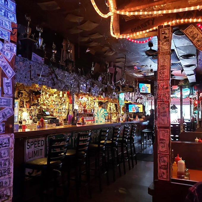 Dollar bills wallpaper the interior like a shrine to satisfied customers past. This isn't ambiance—it's a living museum of burger pilgrimages.