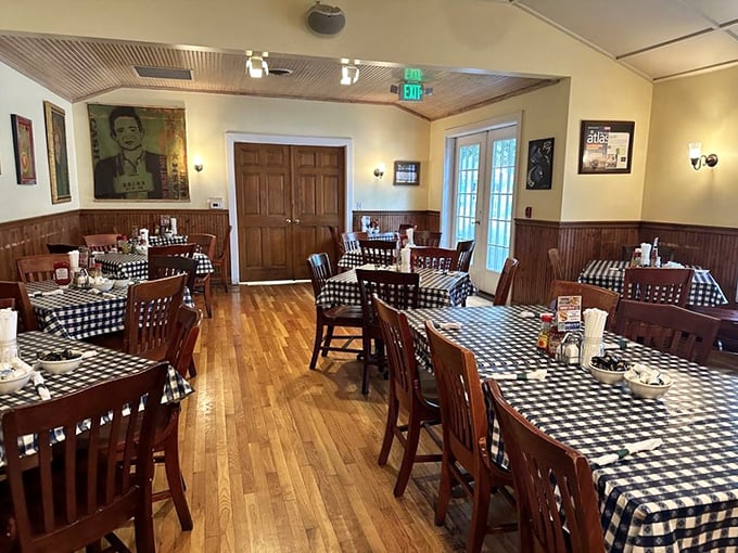 Classic wooden chairs, black and white checkered tablecloths, and warm wood paneling &ndash; this dining room hasn't changed because it doesn't need to.