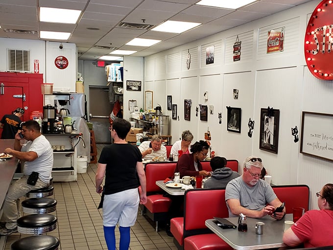 Classic red vinyl booths and counter seating create that perfect diner atmosphere where conversations flow as freely as the coffee.