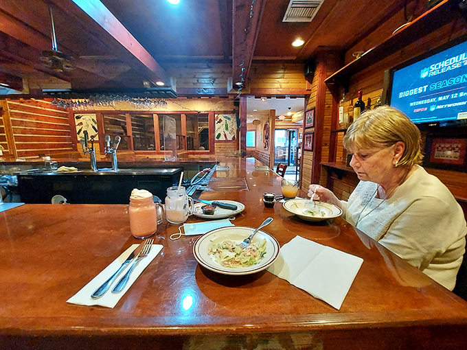 Warm wood paneling creates the perfect backdrop for hearty meals, where diners savor comfort food classics in a relaxed atmosphere.
