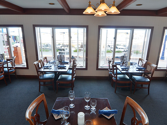 Tables with a view! The dining room's large windows frame Newport Harbor like living paintings, turning every meal into dinner and a show.