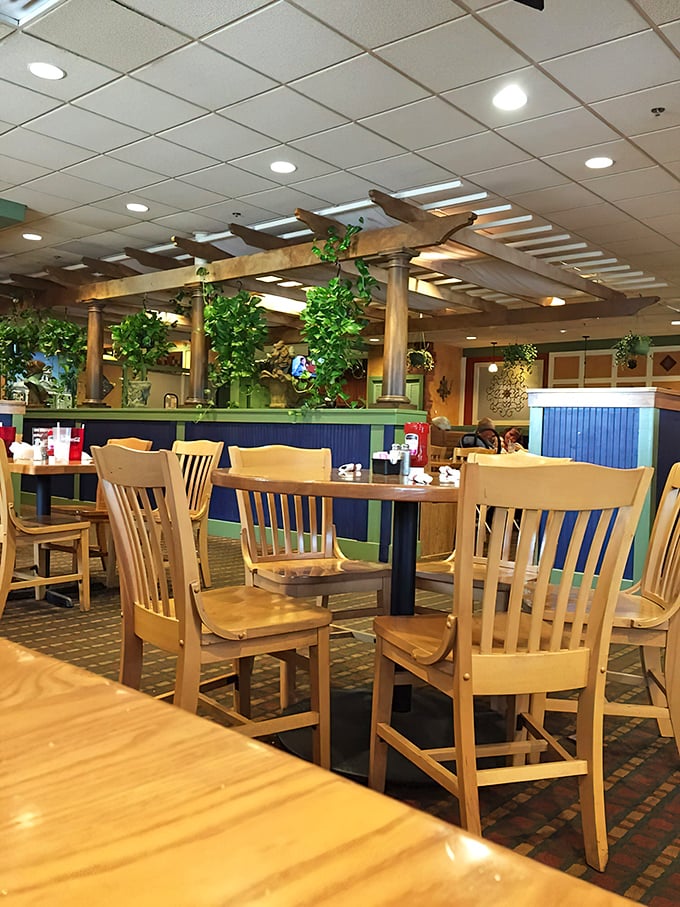 Inside, wooden pergolas and lush greenery create dining zones that feel both spacious and intimate. Comfort by design, not by accident.