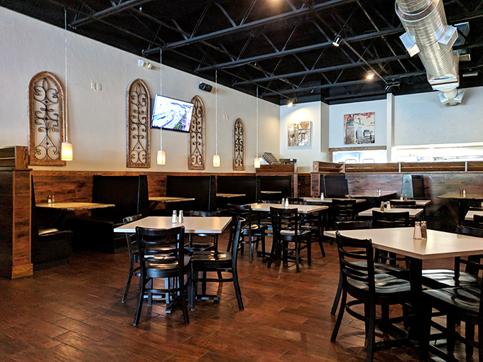 Inside, warm wood tones and decorative ironwork create that perfect sweet spot between "neighborhood joint" and "place worth driving for."