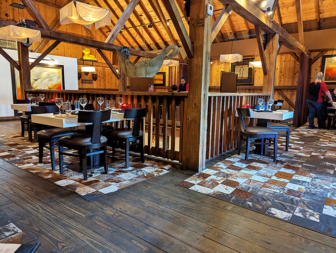 Exposed wooden beams and thoughtful lighting transform this former barn into a cathedral of carnivorous delights where history meets culinary artistry.