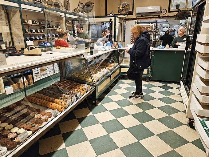 Inside Oram's, the checkered floor and glass display cases aren't just decor—they're time machines to when donuts were made with patience and pride.
