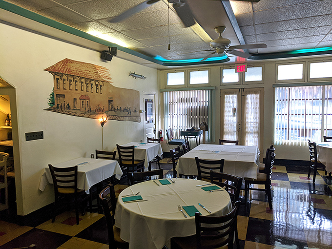 Classic black and white floors, crisp white tablecloths, and that subtle blue lighting&mdash;Temptation's dining room whispers "the food is the real star here."