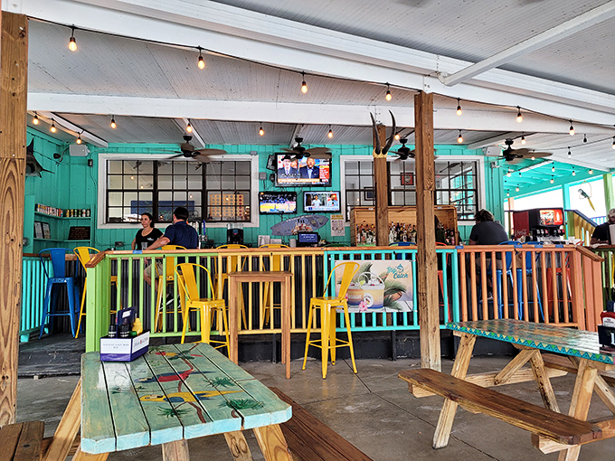 Colorful railings, string lights, and weathered wood create that perfect "I'm on vacation" vibe, even when you're just on your lunch break. 