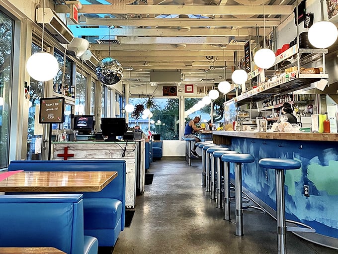 Step inside and time-travel to a bygone era where blue booths and hanging globe lights create the perfect backdrop for your comfort food fantasies.