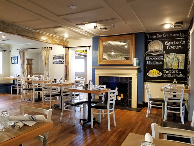 Wooden floors, white chairs, and that navy accent wall with a fireplace create the perfect setting for serious breakfast contemplation.