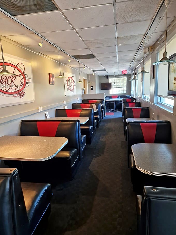 Classic black and red vinyl booths invite you to slide in and stay awhile &ndash; each one a front-row seat to the timeless theater of diner life.