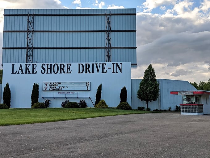 The iconic blue facade announces current features with charming simplicity. No fancy digital displays needed when you've got classic movie magic to deliver.