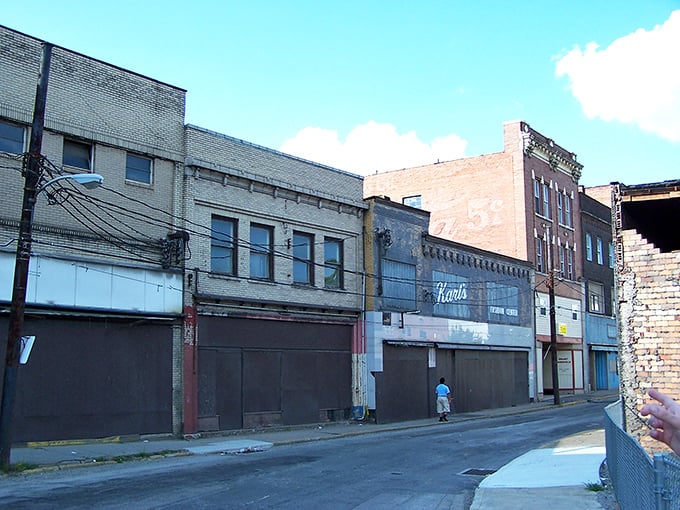 Faded storefronts stand like patient sentinels, waiting for their second act in a town where history whispers from every brick.