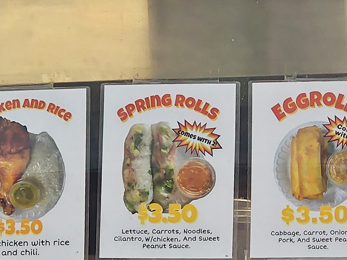 The menu board tells a delicious story in three acts: chicken and rice, spring rolls, and egg rolls&mdash;simple perfection that needs no Broadway production values to shine.