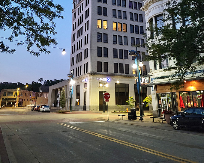 As twilight embraces downtown Moline, the city's historic buildings glow with possibility, their windows like constellations against the deepening blue sky.