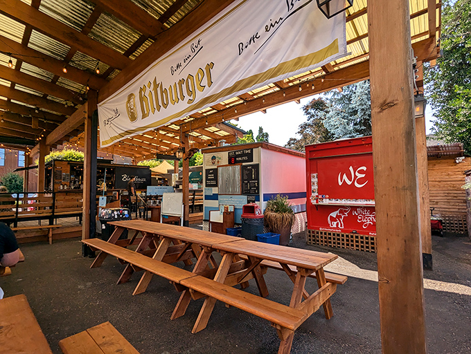 Communal dining under the Portland sky, where picnic tables and a Bitburger banner create the perfect backdrop for meat-induced euphoria and new friendships.