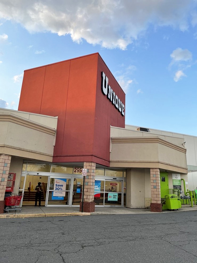 Blue skies frame the distinctive entrance where savvy shoppers arrive with empty bags and leave with stories to tell.