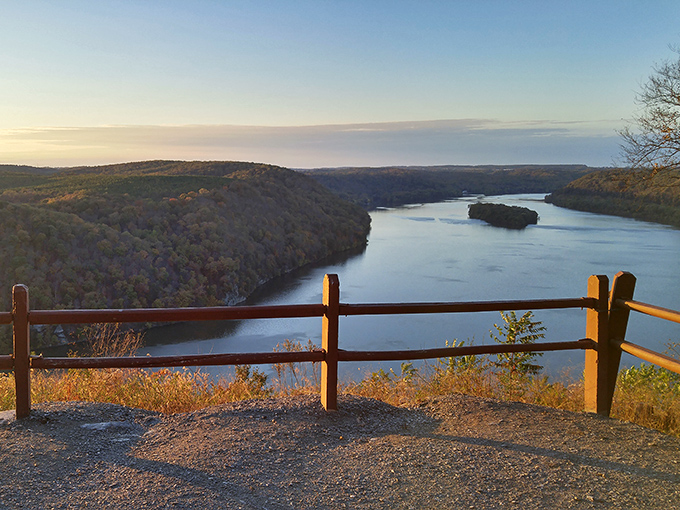 Golden hour magic transforms the overlook into a painter's dream. That wooden fence isn't just for safety&mdash;it's the dividing line between ordinary life and extraordinary views.