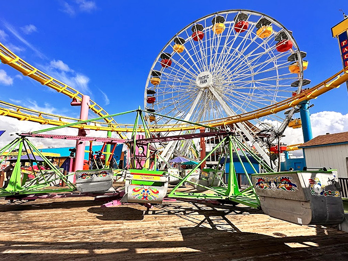 Colorful carriages spin against endless sky, where the Pacific Wheel and Scrambler rides promise giddy thrills regardless of your age.