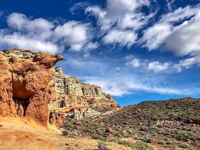 Nature's own layer cake of sedimentary wonder. These vibrant cliffs have been patiently waiting millions of years for your Instagram moment.