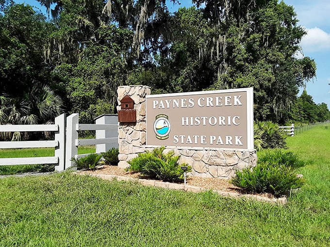 Florida's version of a welcome mat &ndash; rustic stone, white fencing, and Spanish moss that practically whispers "y'all come on in now."