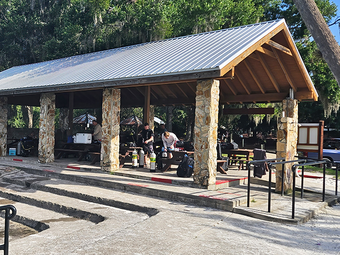 Scuba tanks and adventure gear await beneath this rustic pavilion. The perfect staging area for your underwater expedition.