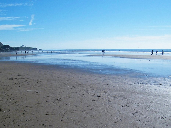 Morning reflections create nature's mirror on Stinson's shore. The kind of emptiness that somehow fills you completely.