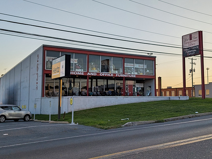 Sunset casts a golden glow on this furniture mecca. The "HOME AND OFFICE FURNITURE" sign promises practical treasures within.