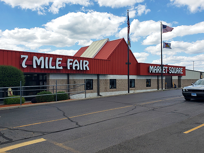 Blue skies frame the distinctive 7 Mile Fair fa&ccedil;ade, where American flags flutter above a building that houses thousands of treasures waiting to be discovered.