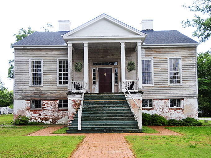 The Caldwell-Johnson-Morris Cottage whispers stories of bygone eras through its weathered wood and brick foundation&mdash;Southern history you can actually touch.