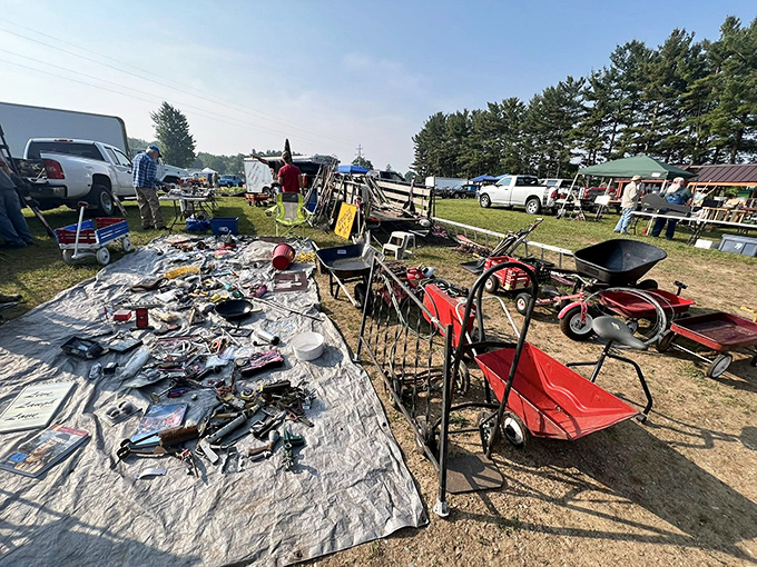 Tool heaven or garden paradise? This vendor's display offers everything from vintage rakes to red wagons, spread across the sunlit grounds.