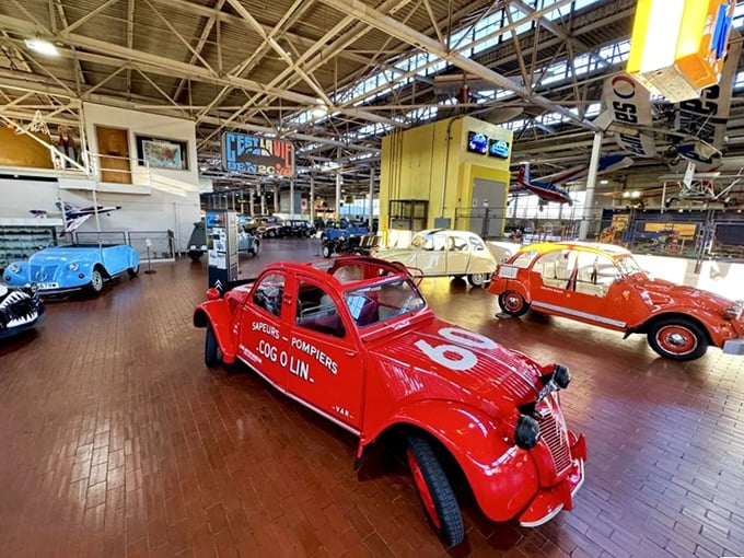 A fire-engine red Citroën 2CV emergency vehicle stands ready to save the day—or at least attempt to at its modest top speed.